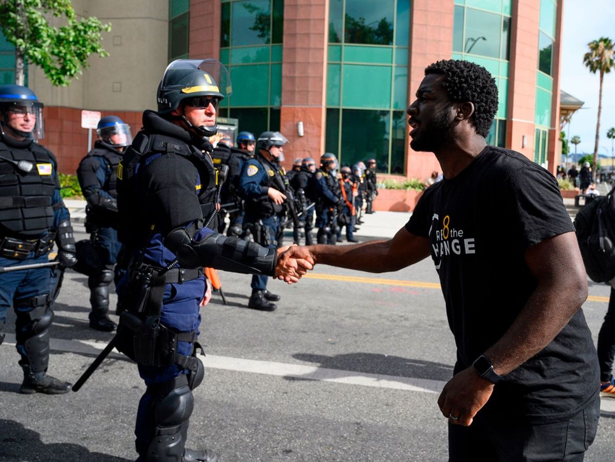Black protesters protect police officer separated from his squad in ...